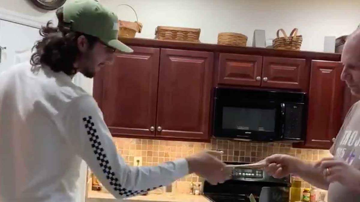 Golfer sinks a miracle shot from a kitchen golf course