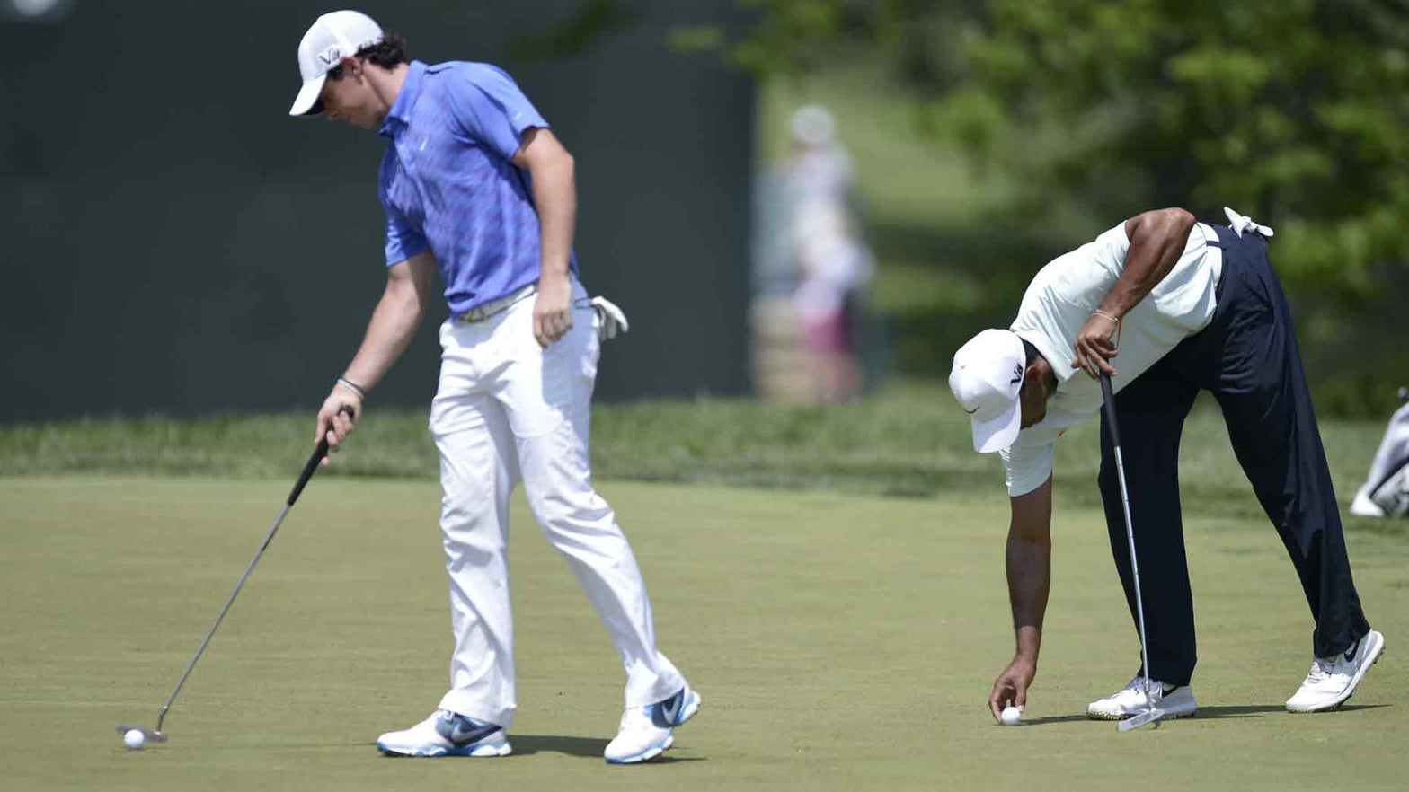 Is it permissible to tamp down the grass around the hole before you putt?