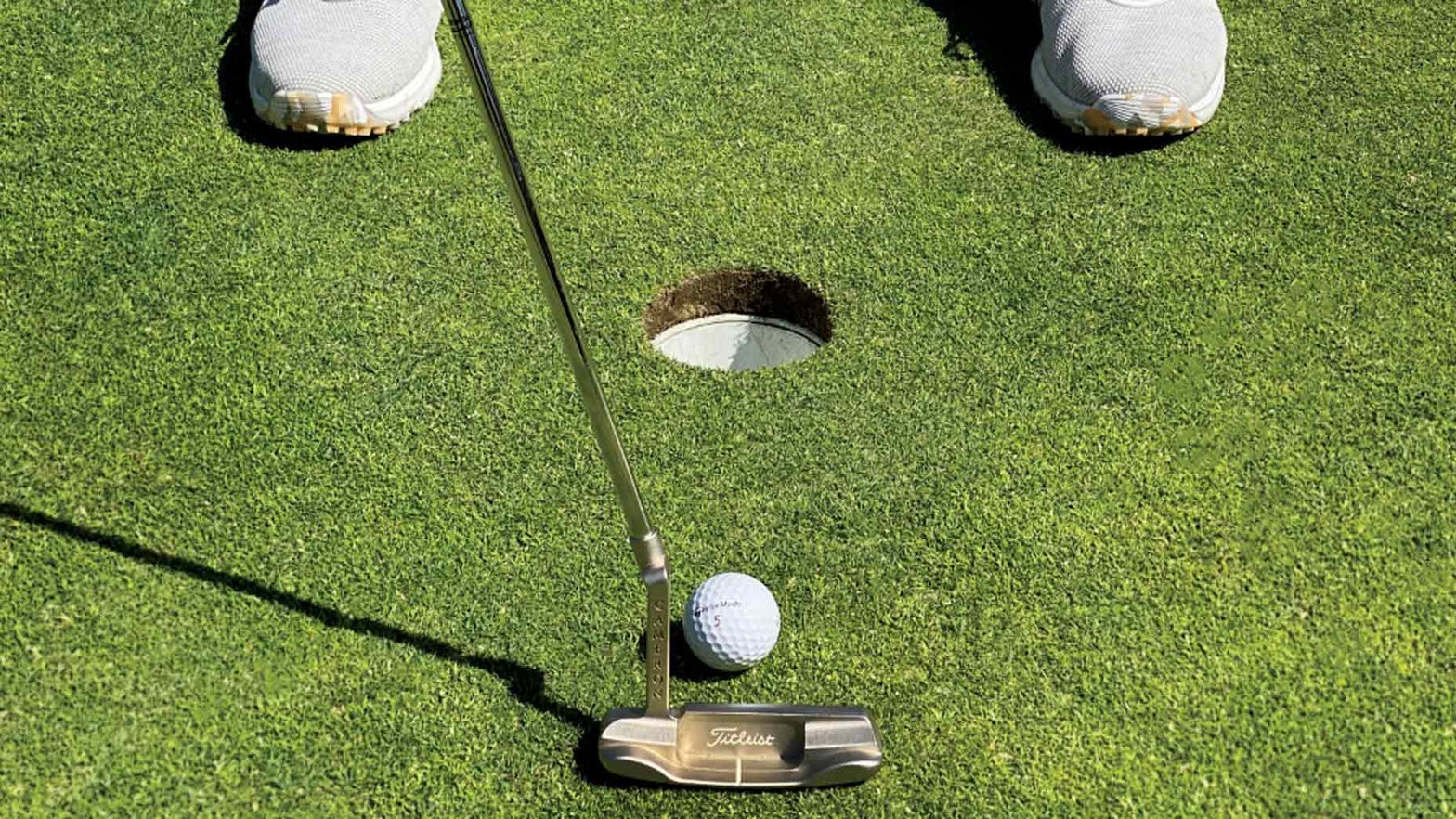 Is it legal to stand on the opposite side of the hole to hit your putt?