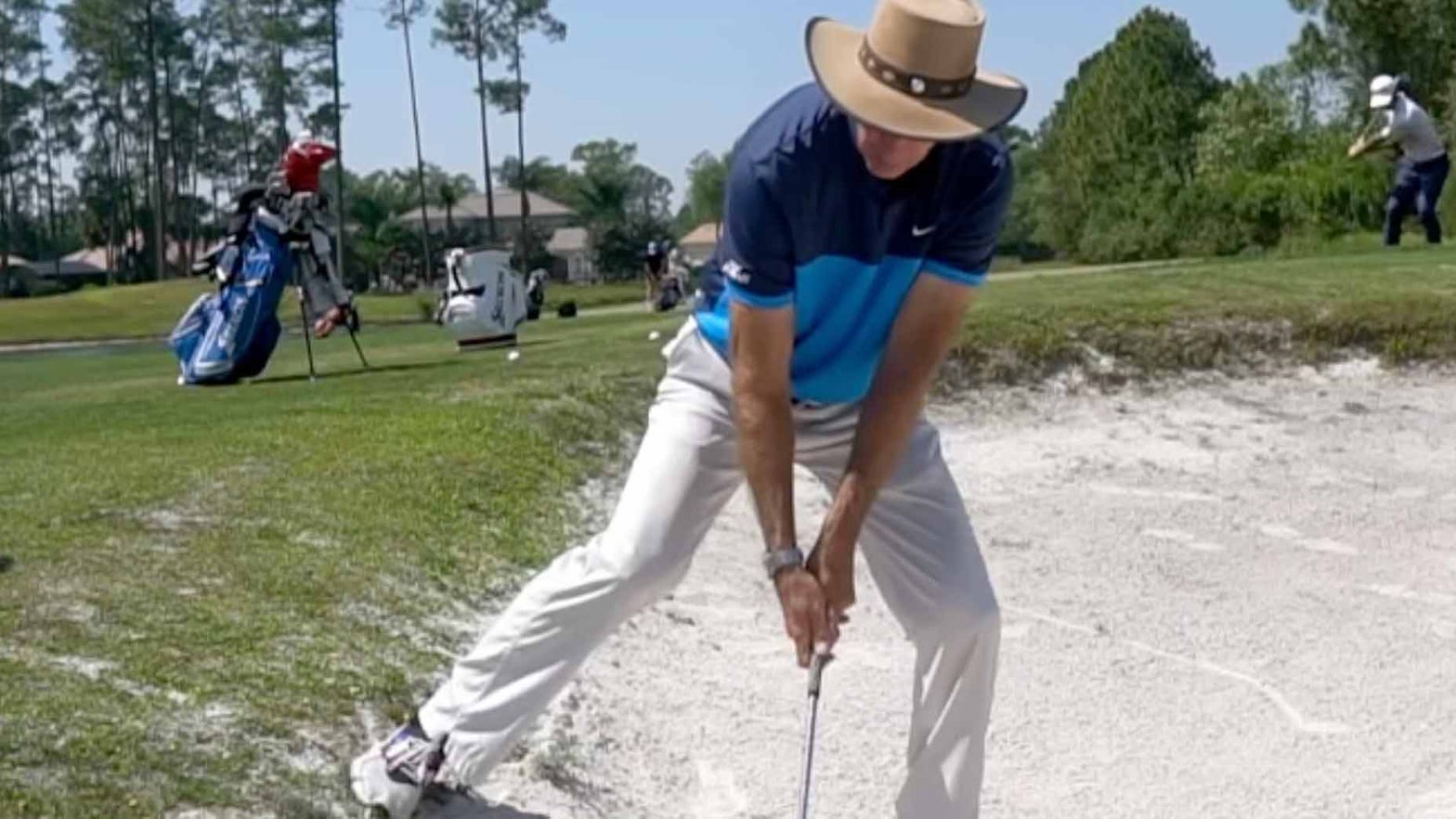 Use this technique to overcome a downhill lie in a greenside bunker