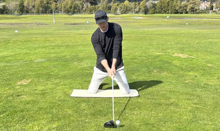 How hitting a driver while kneeling can clean up your swing