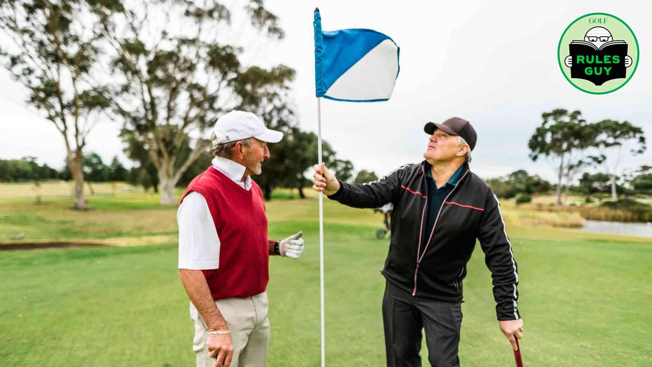 Can my playing partner hold the flag, but keep the pin in while I putt?